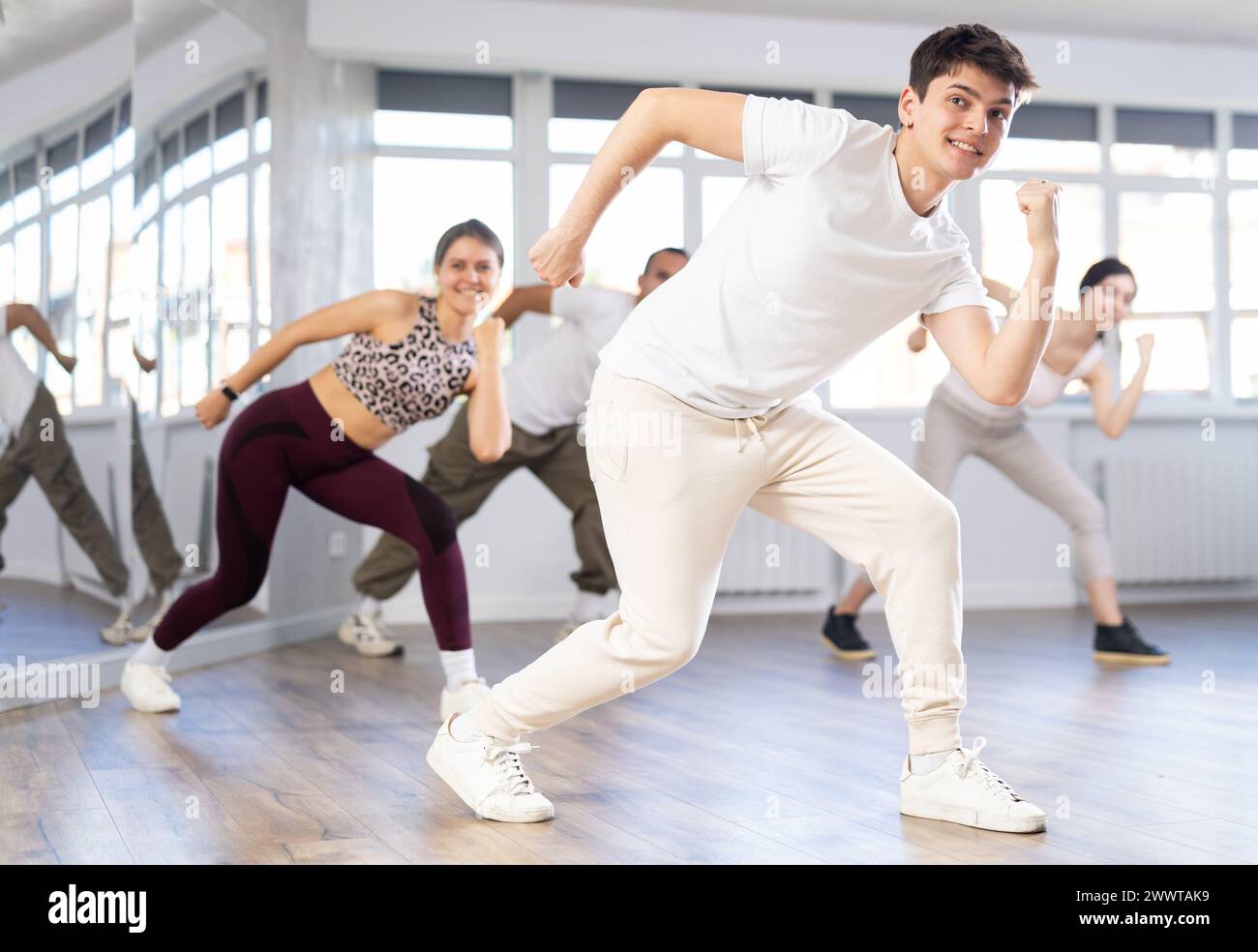 Group of people, girls and guys in sportive casual style clothes ...