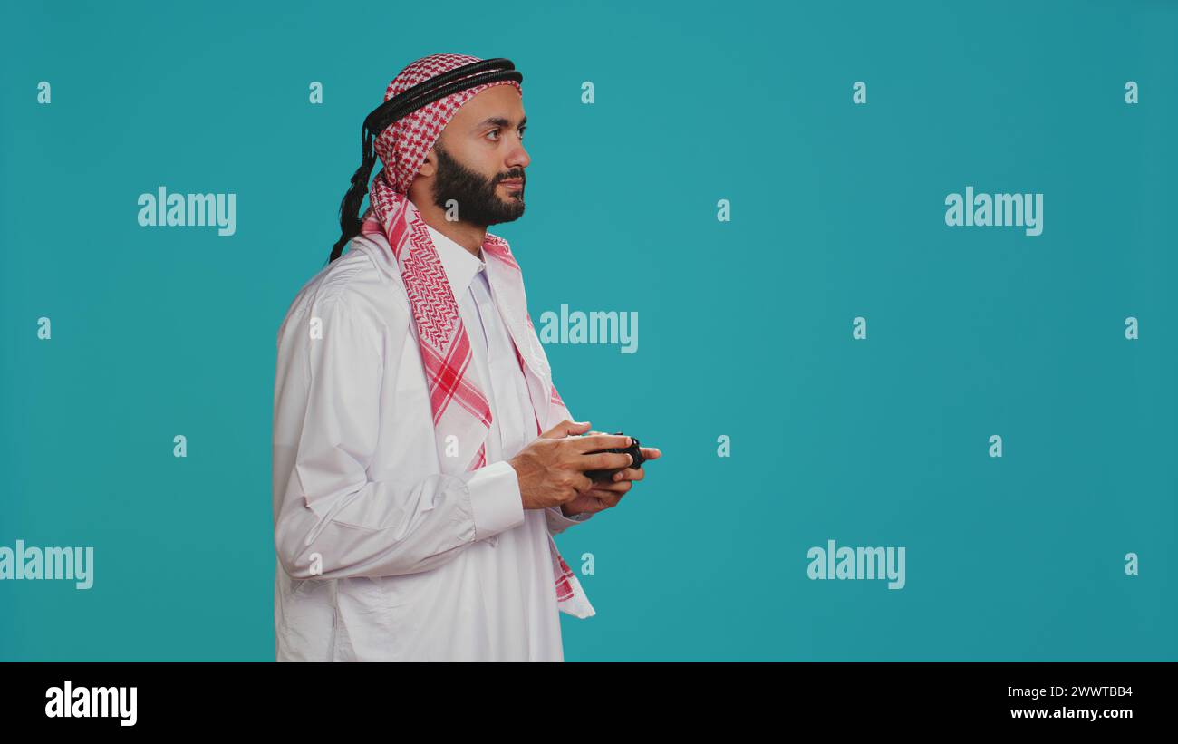 Modern man playing games with controller, having fun with video gaming ...