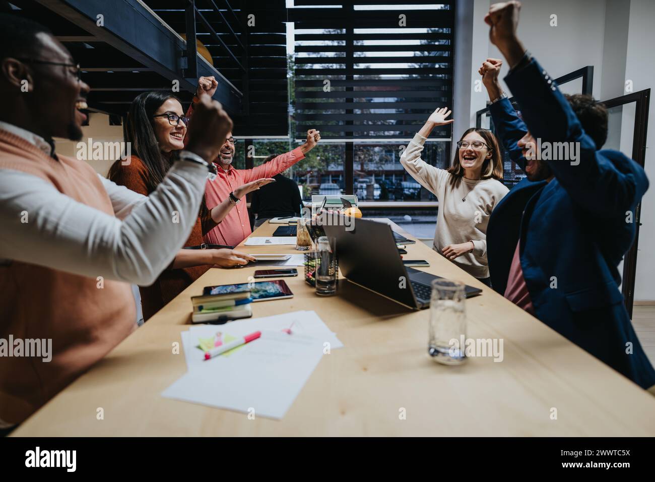 A cross generational team collaborating late into the night, focused on ...