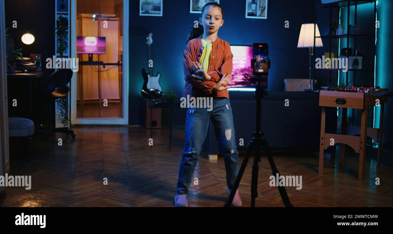 Panning shot of viral media star dancing in apartment, recording video ...