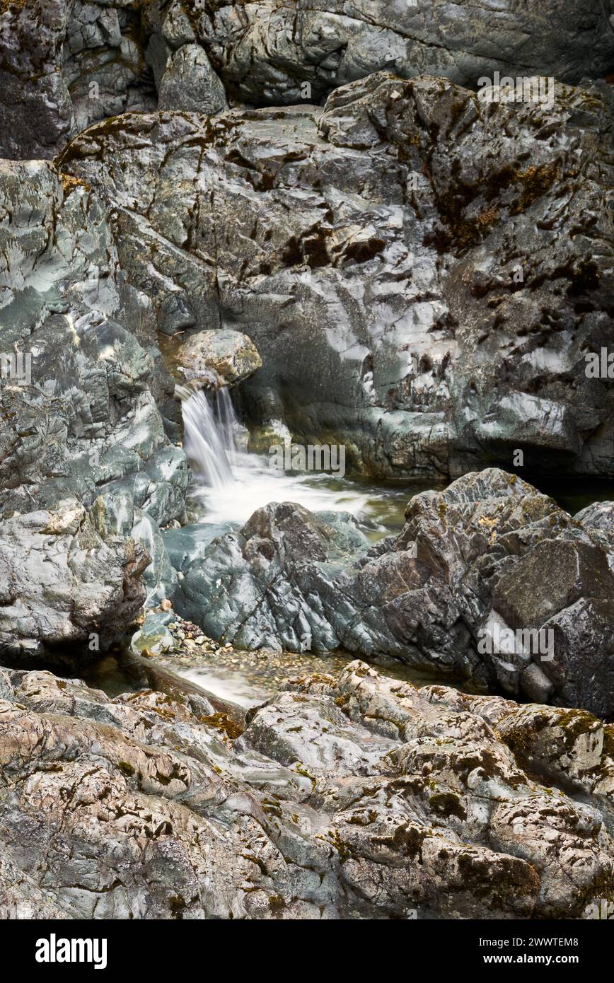 A tiny waterfall amongst beautiful rugged rocks at Harris Creek Stock ...