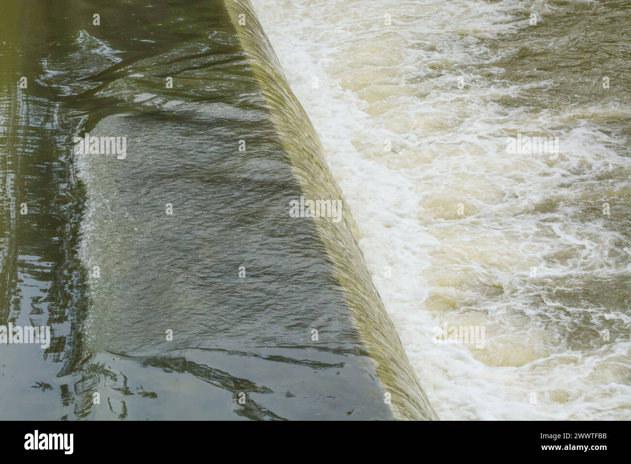 A fast-flowing stream and dramatic lenticular clouds against a dark sky ...