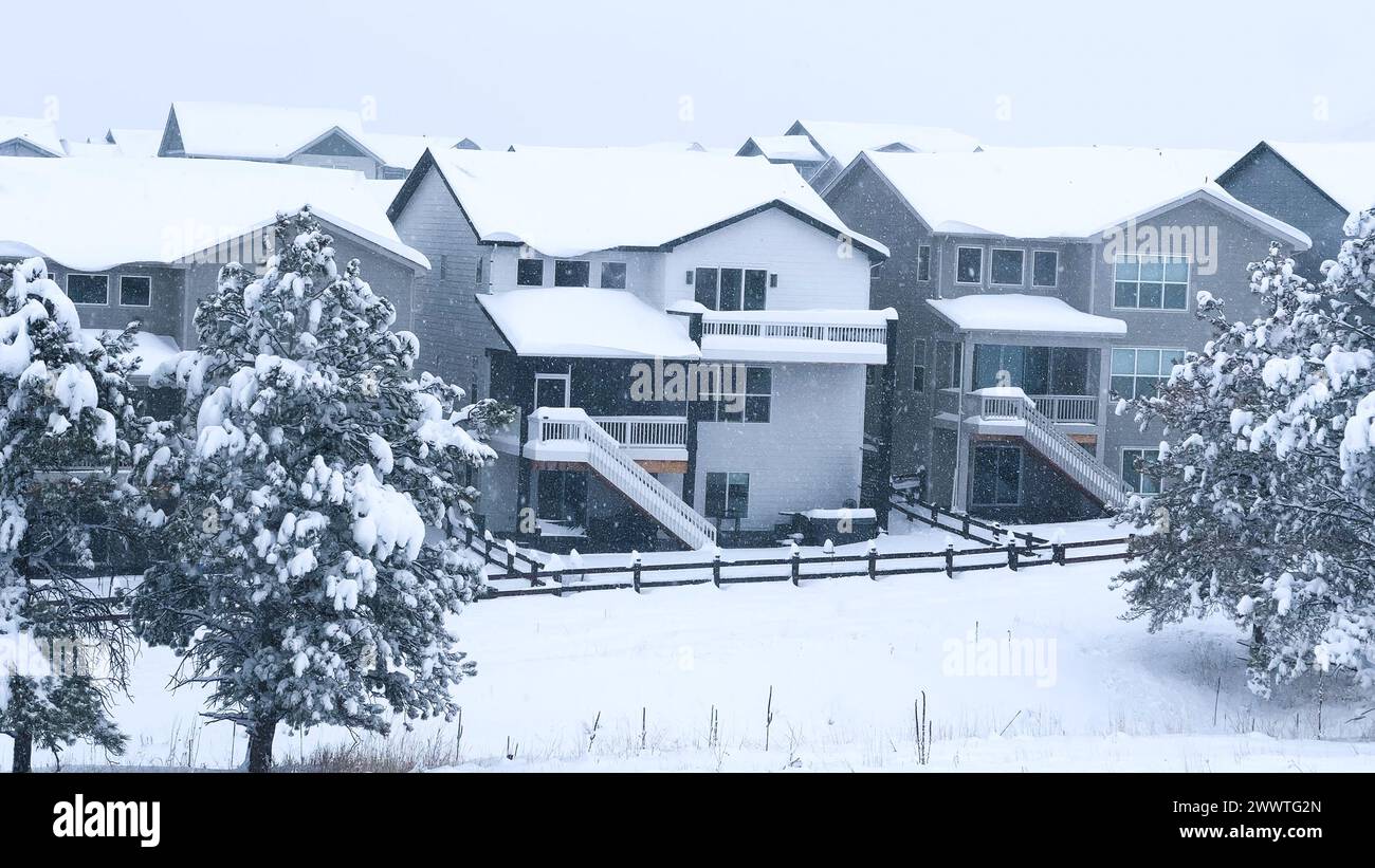 Winter Embraces Suburban Homes with Gentle Snowfall and Serene Skies ...