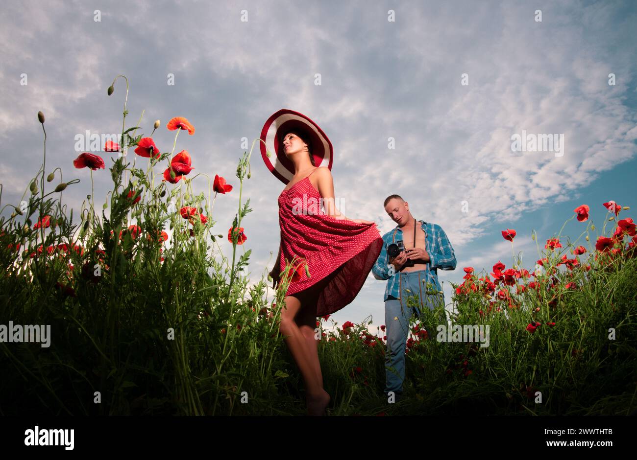 Photographer shooting lady in dress at poppy summer field. Well being ...