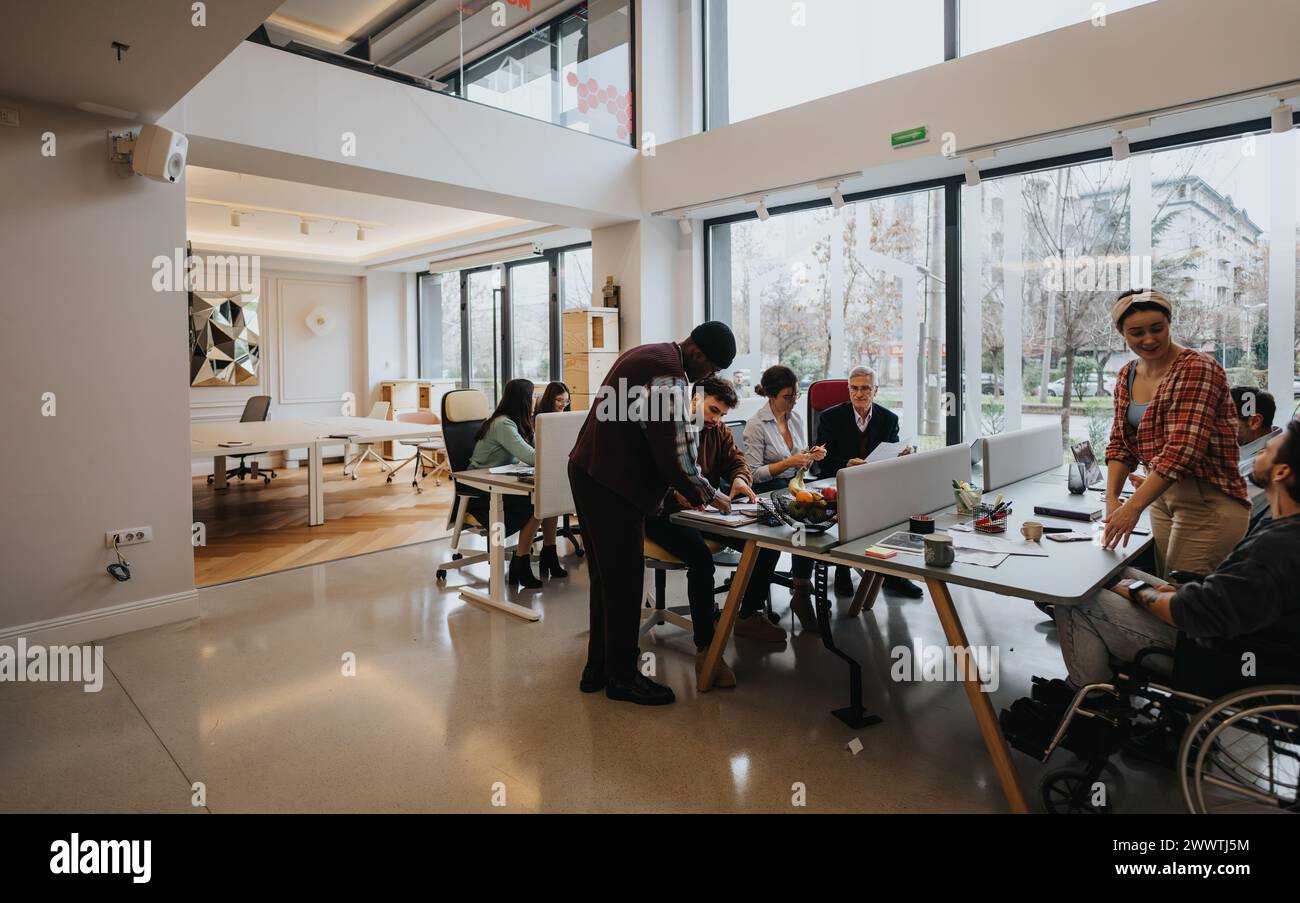 A multicultural group of colleagues collaborates in a well-lit ...