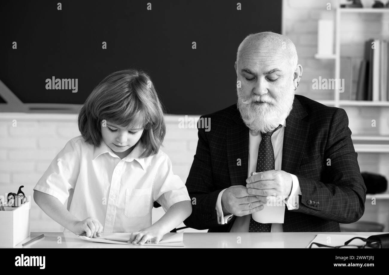 Teacher and pupil in classroom. Help to learn. Education concept ...