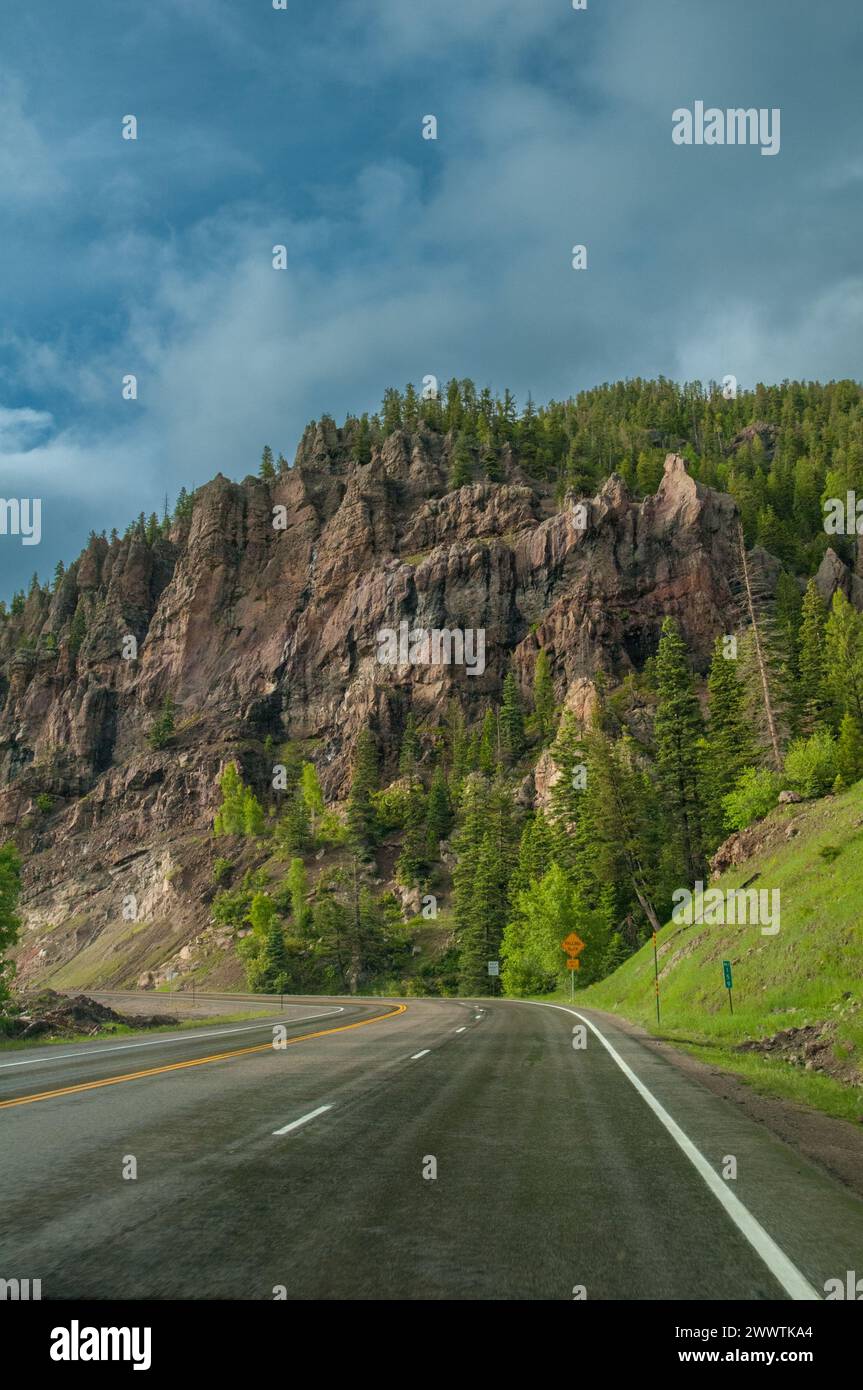 This vibrant image captures a picturesque journey along a road cutting ...