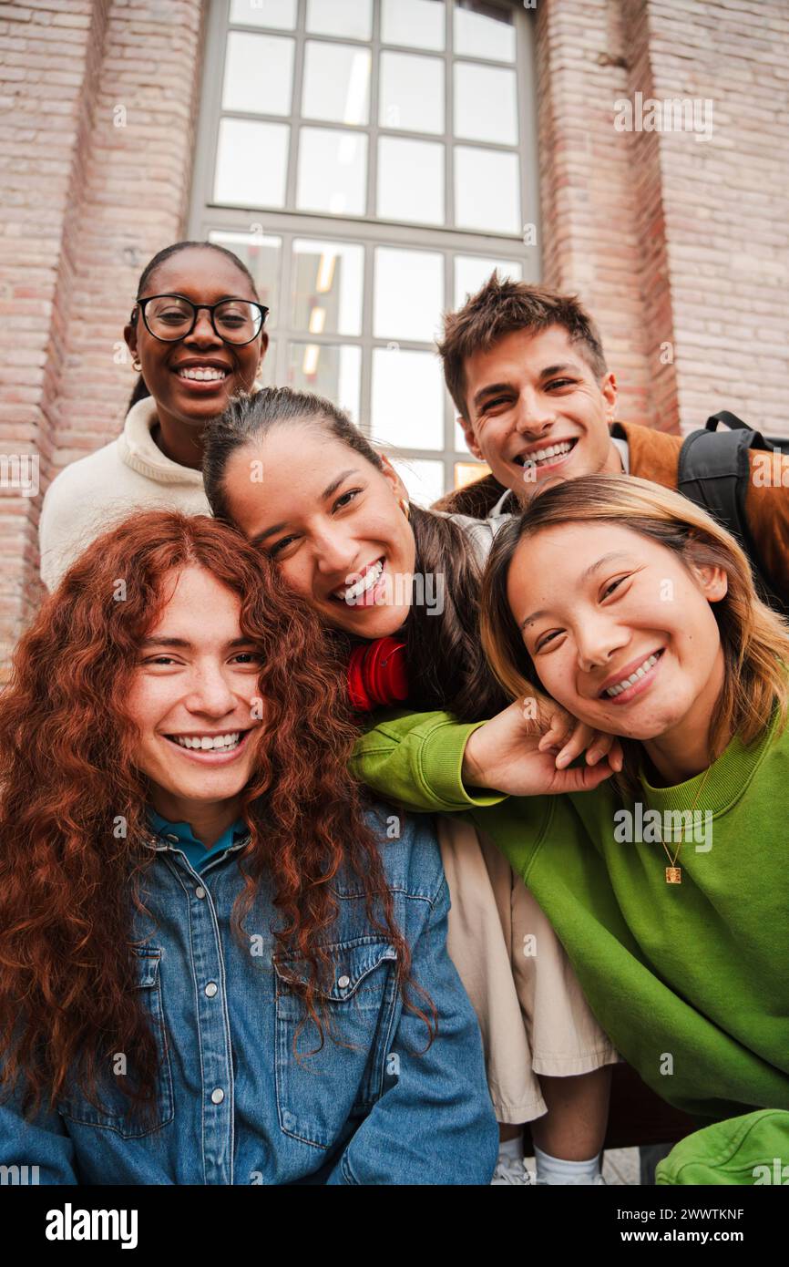 Vertical portrait of a group of friends having fun and smiling together ...