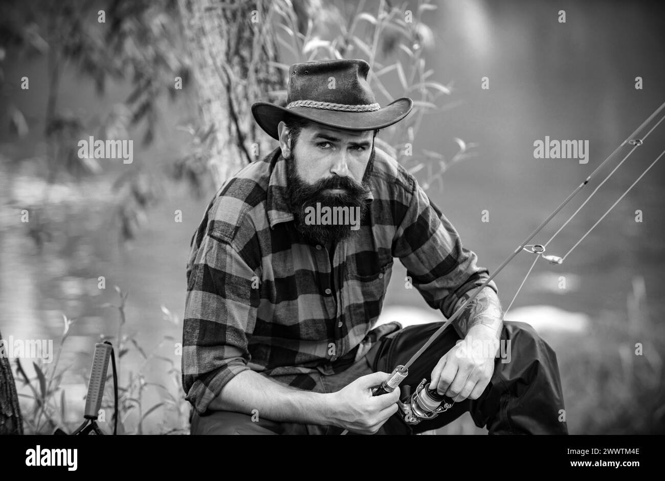 Young man angler fishing. Fisherman with rod, spinning reel on river ...
