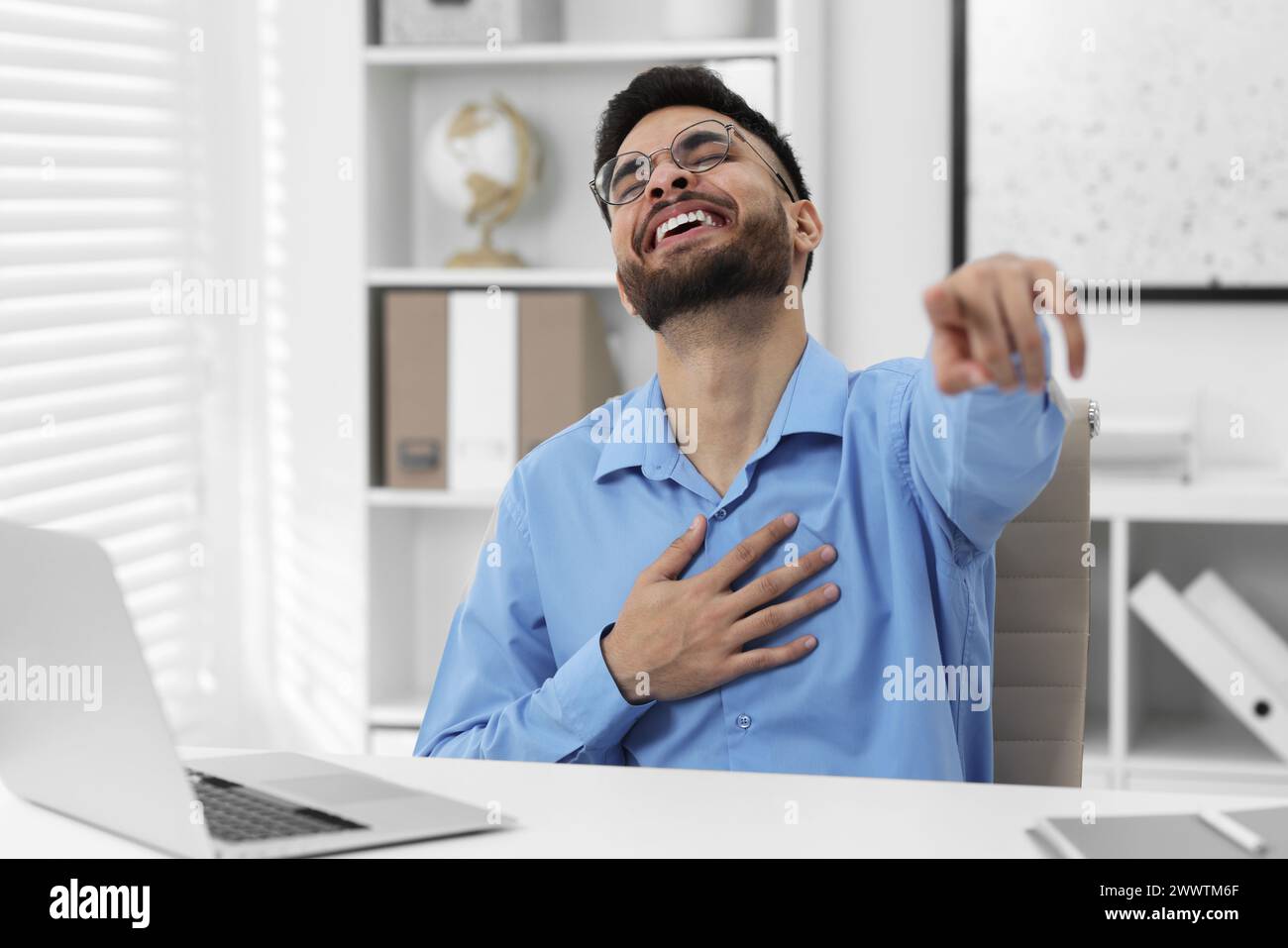 Young businessman pointing laughing funny hi-res stock photography and ...
