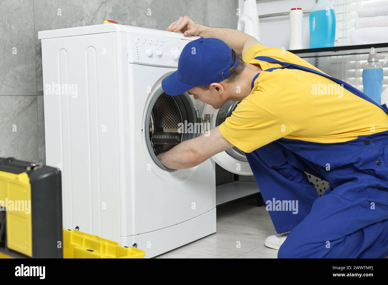 Plumber repairing washing machine hi-res stock photography and images ...