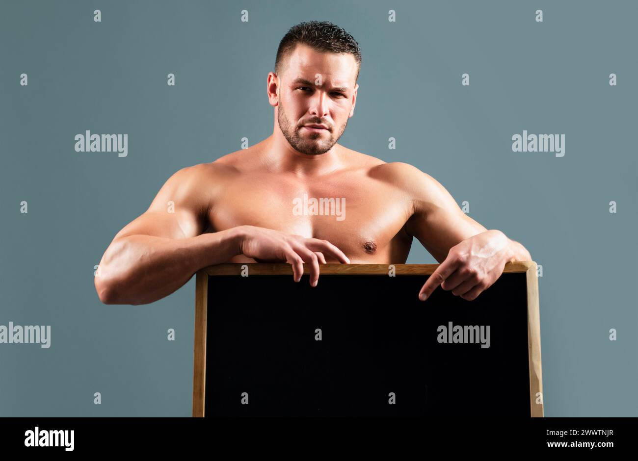 Advertising concept. Fitness man with sign board. Strong bodybuilder ...