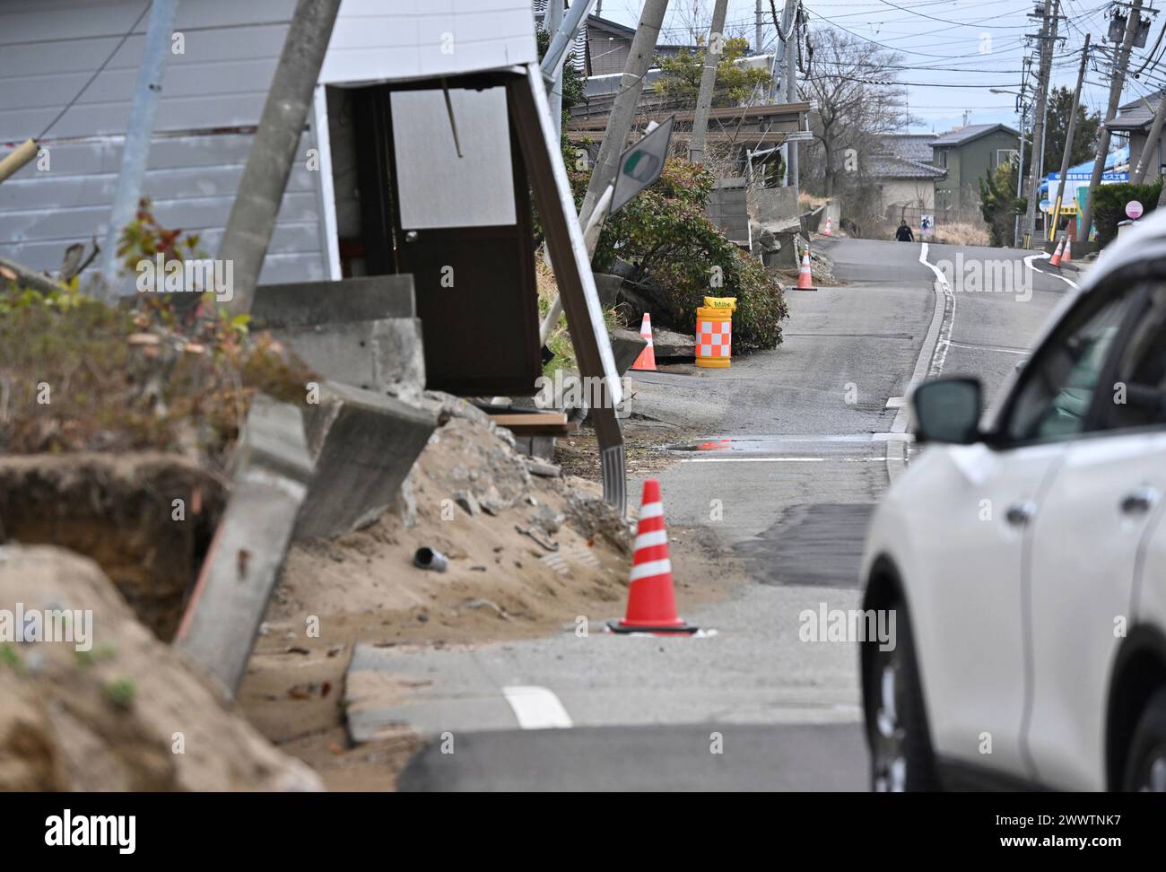 Buildings and roads are severely damaged by liquefaction followed by an ...