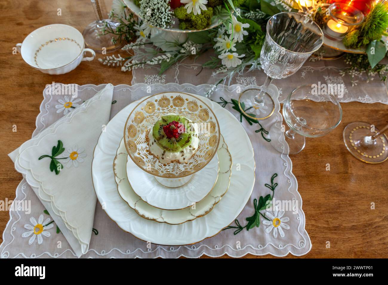 Mini cheesecake with kiwi, raspberry and edible gold garnish on a ...