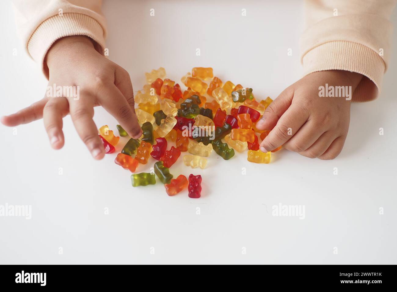 child hand pick colorful sweet candy Stock Photo - Alamy