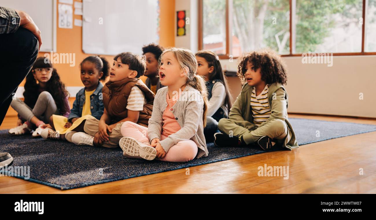 Little kids saying the vowel sounds out loud. Group of elementary ...