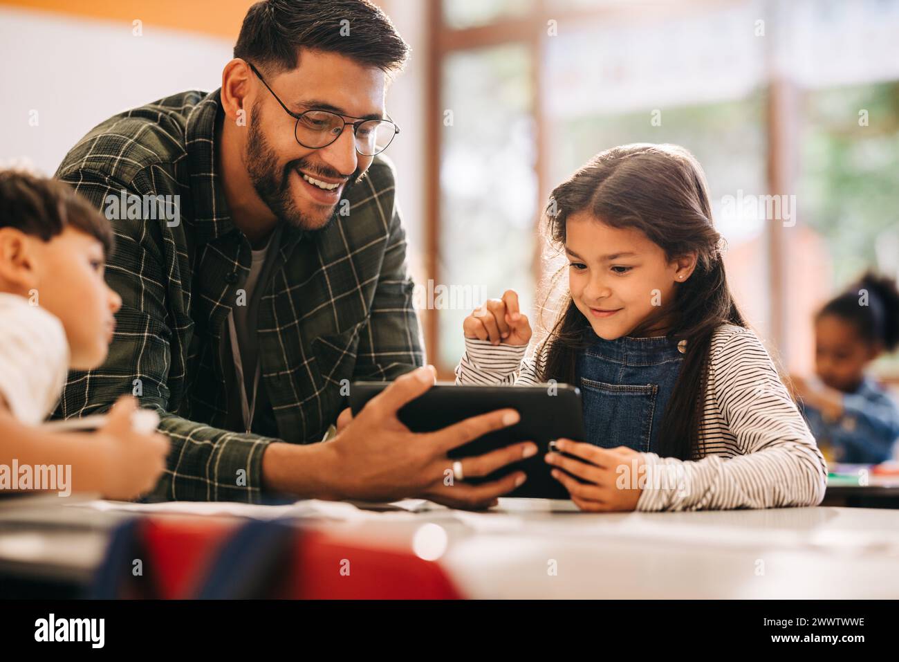 Coding and digital literacy in elementary school. Teacher gives a ...