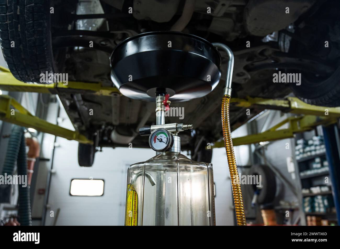 The process of changing the oil in a car engine. Draining old dark used ...