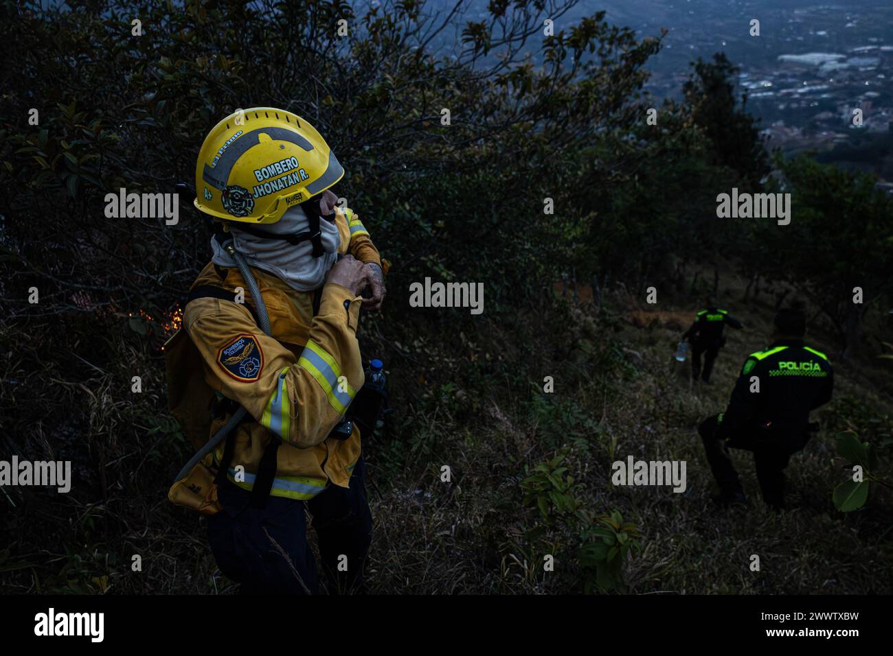 Medellin, Colombia. 25th Mar, 2024. Firefighters and members of the ...