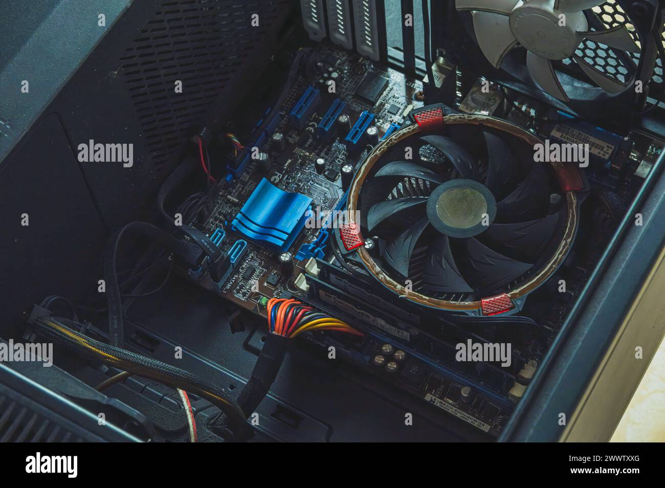 A close-up view of the inside of a broken desktop computer case ...