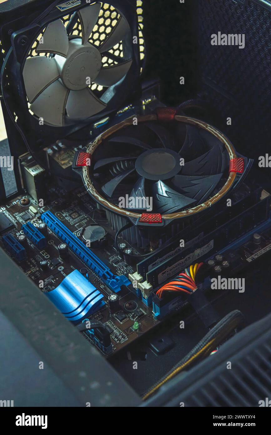 A close-up view of the inside of a broken desktop computer case ...