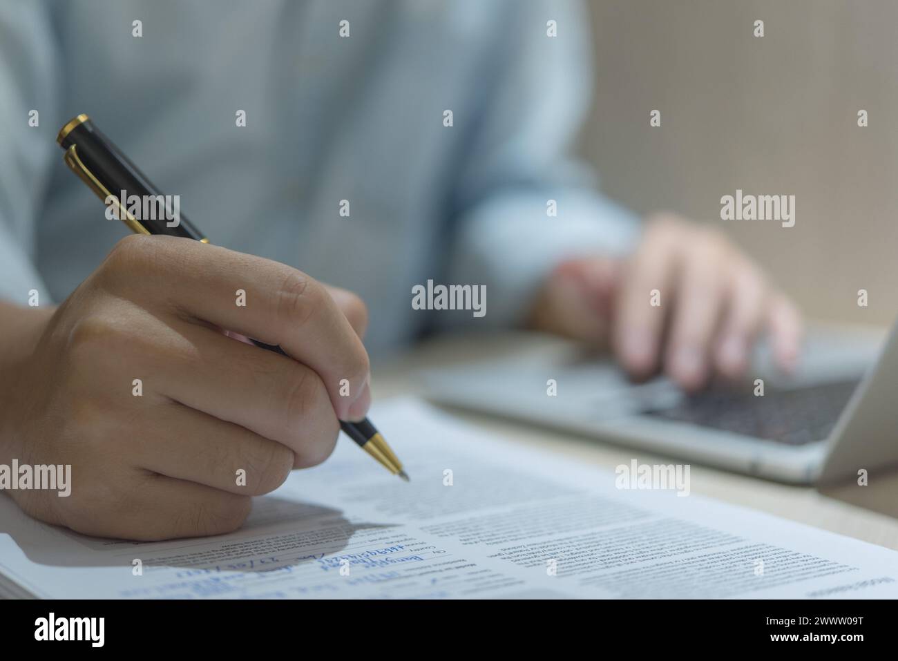 Male hands writing a contract on work paper or signing a business ...