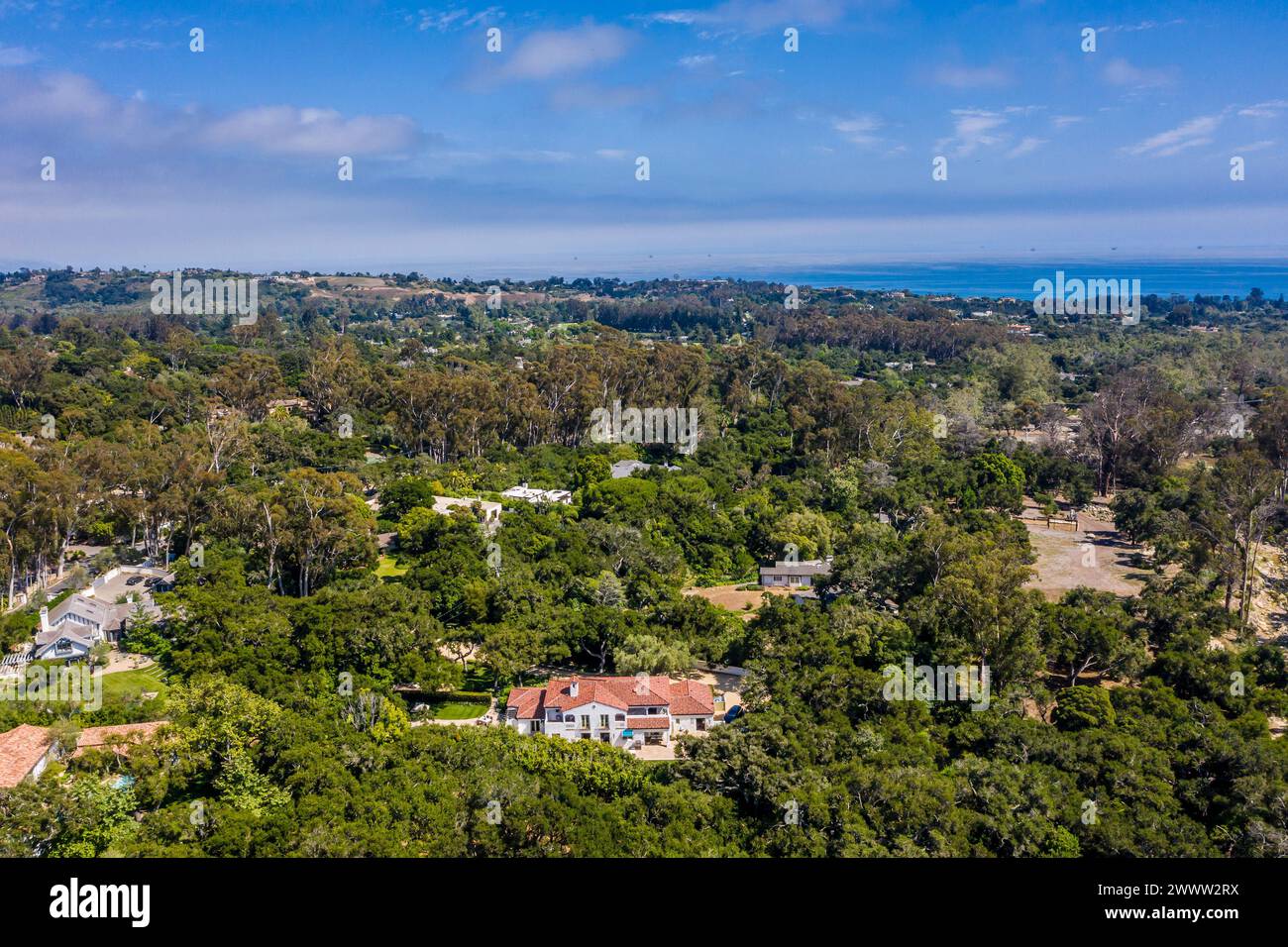 Aerial view of a small town surrounded by trees, captured by a drone ...