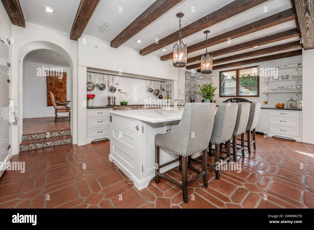 Kitchen with wooden beams and brown tile floors Stock Photo - Alamy