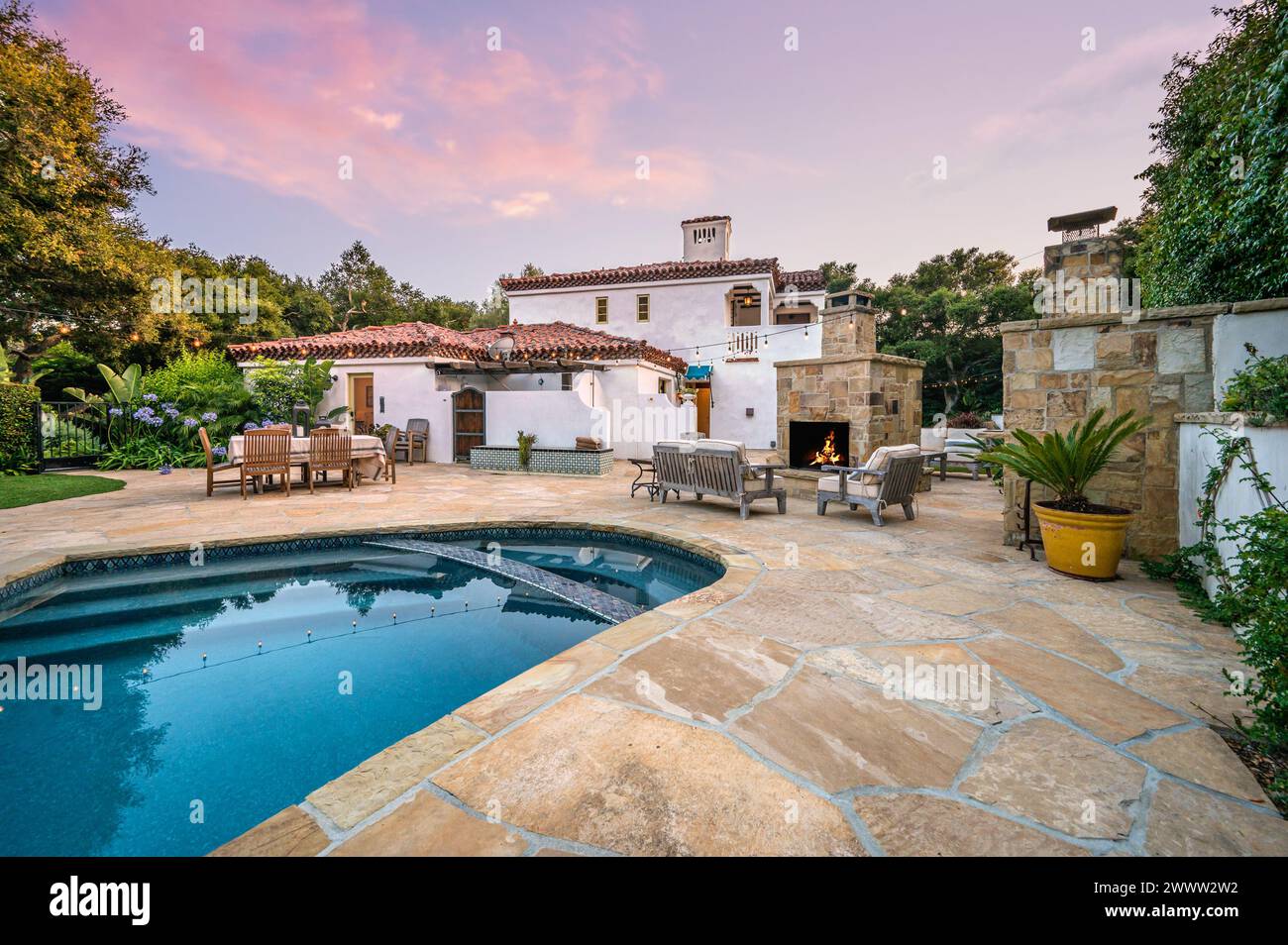 Scenic backyard with pool and dining area Stock Photo - Alamy