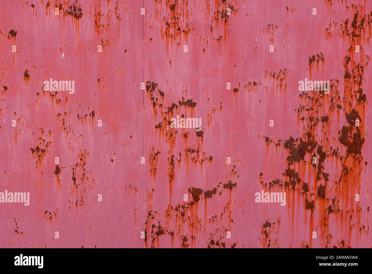 rusty red sun faded paint on flat sheet metal surface full-frame ...