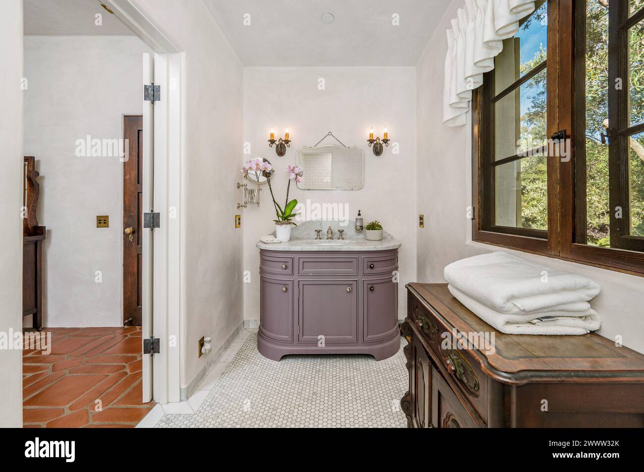 Bathroom with vanity and centered window Stock Photo - Alamy