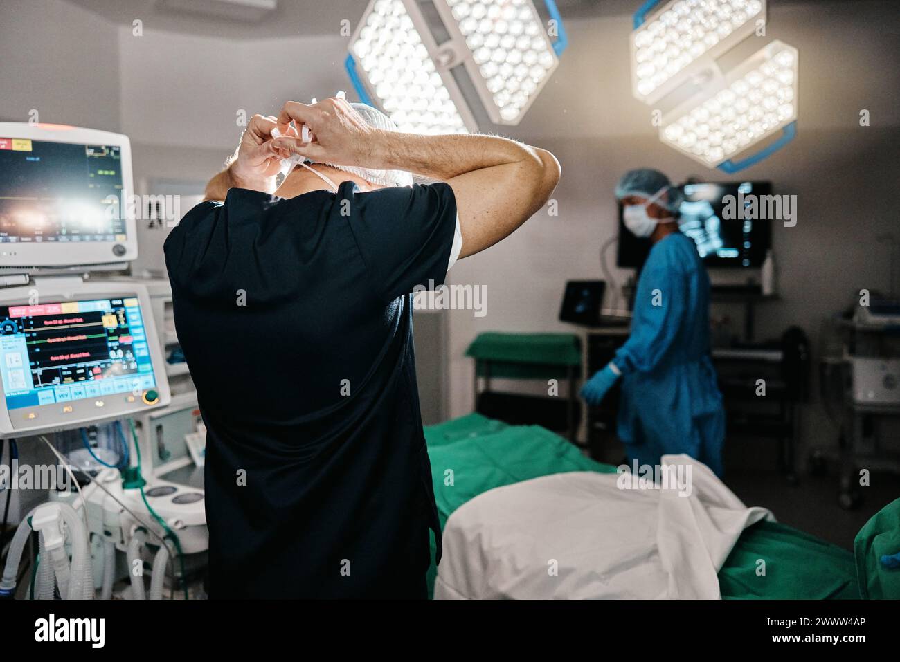 Surgery, healthcare or doctor with mask in operating room, theater or ...