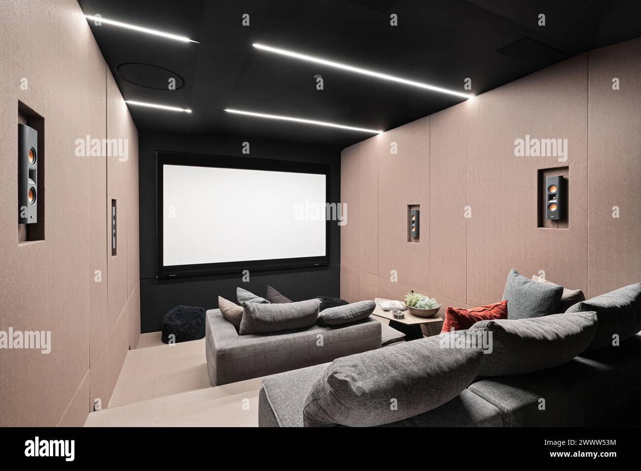 Comfortable living room with seating and wall-mounted TV Stock Photo ...