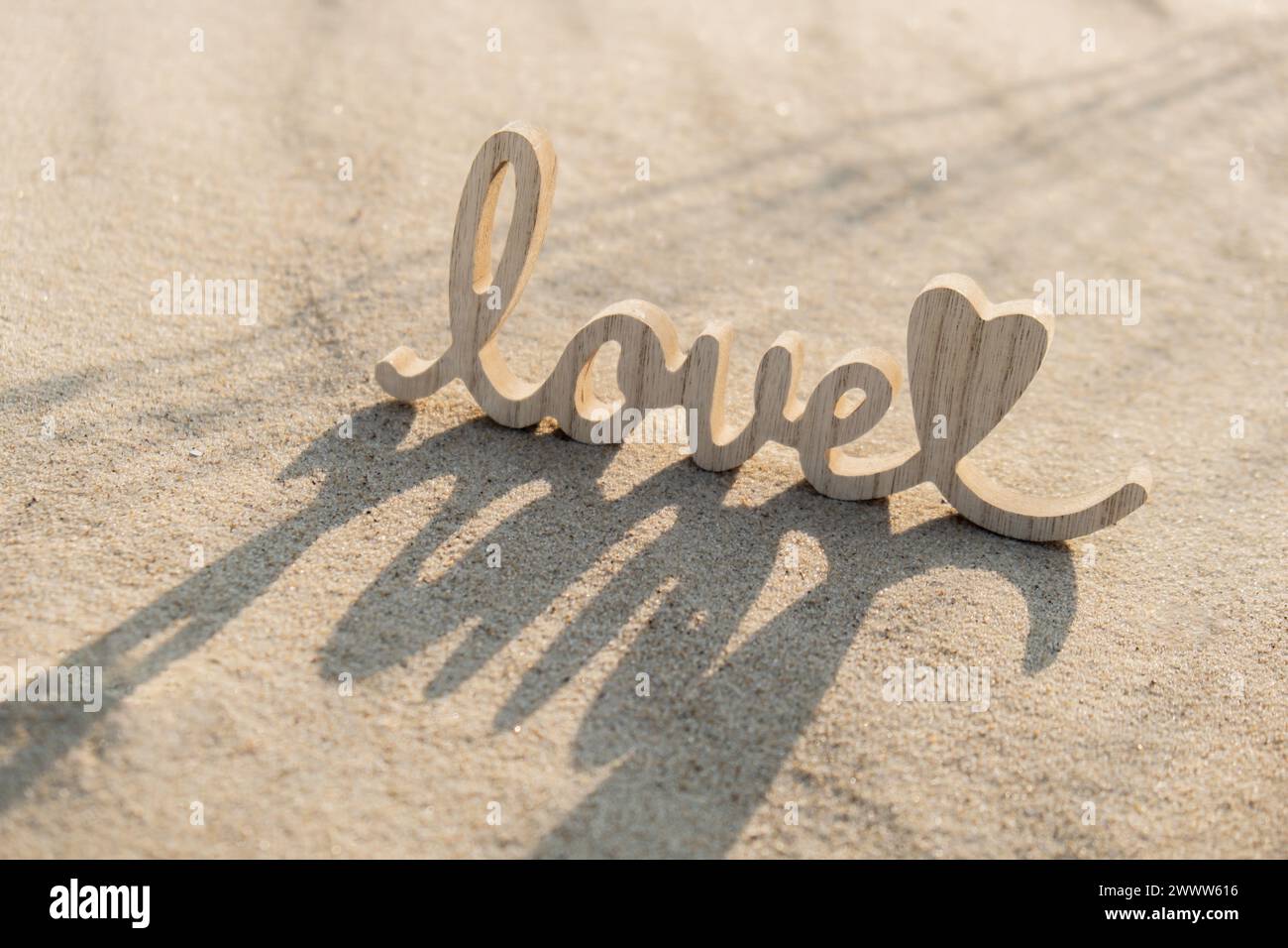 Wooden word love on sandy beach background. Concept of romantic holiday ...