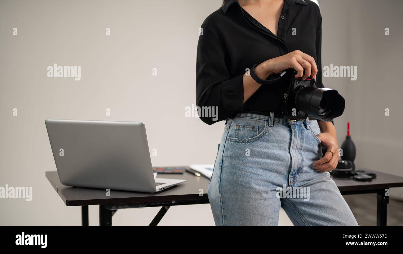 A cropped shot of a confident, professional female photographer in a ...