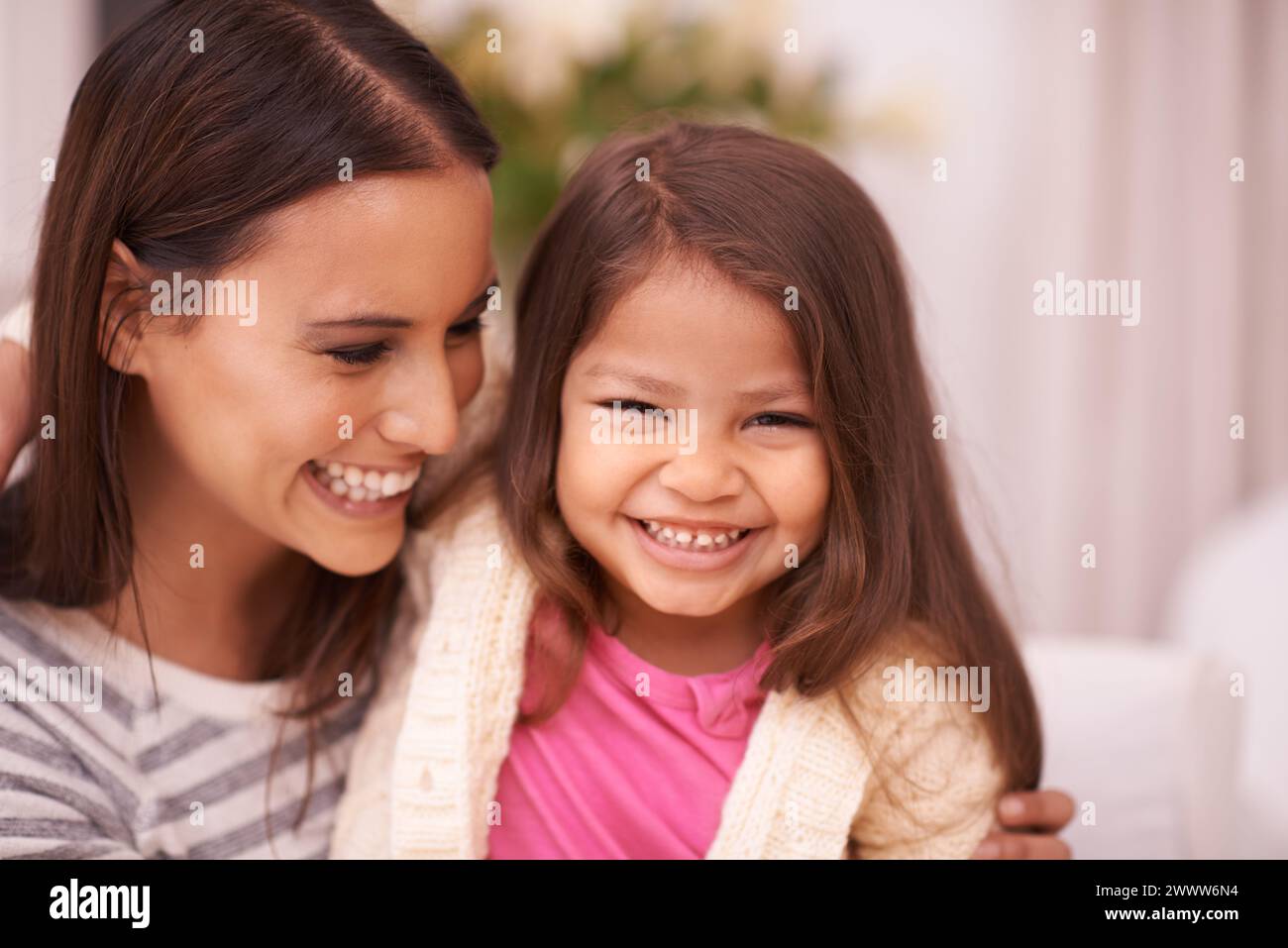 Portrait, mother and daughter with smile for hug in apartment with love, care and happiness ...