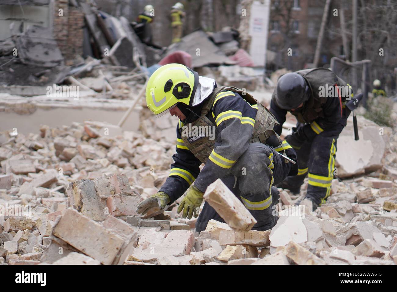 Kiev, Ukraine. 25th Mar, 2024. Rescuers work among the rubble after a ...