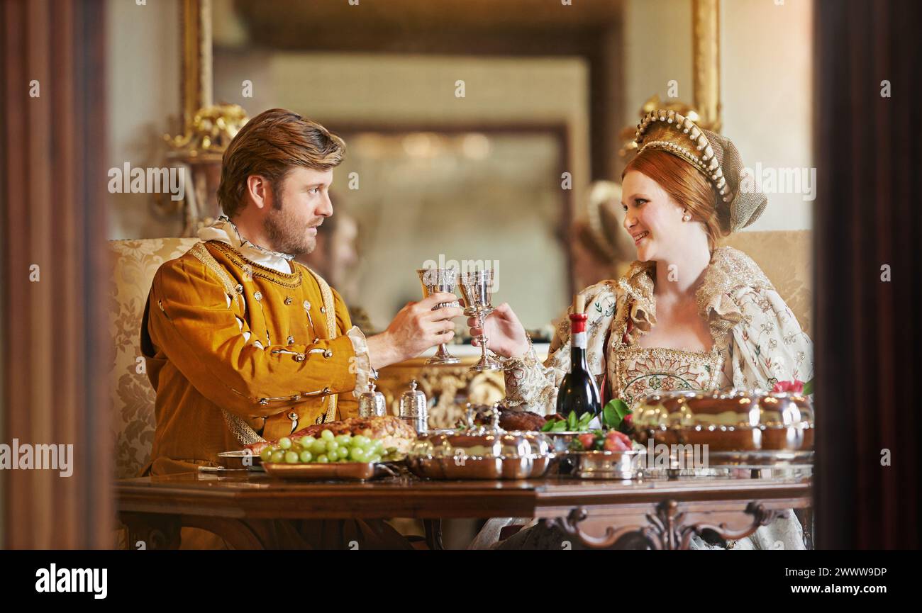 Royal, man and woman with luxury for dinner, wine and toast together ...