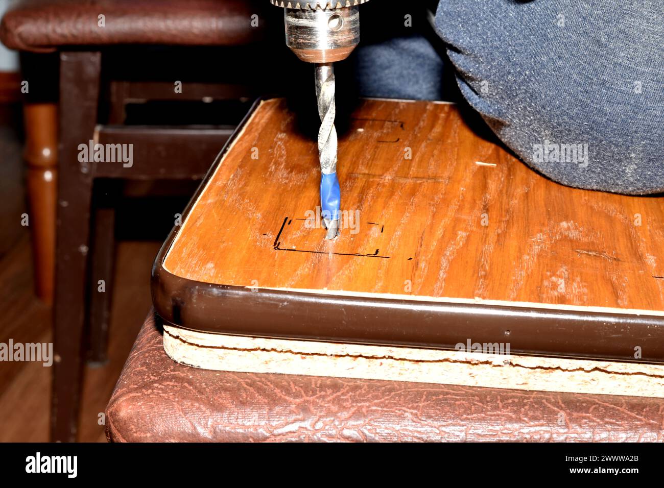 Drill a hole in the board with a drill. Carpentry works. A tool for ...