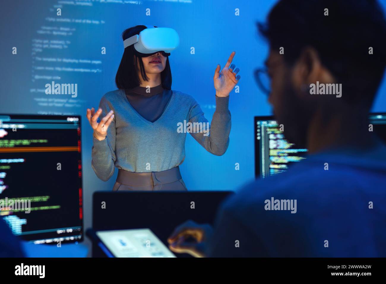Asian And Indian Developer Devops Team Testing Virtual Reality Coding And Presentation With Ai