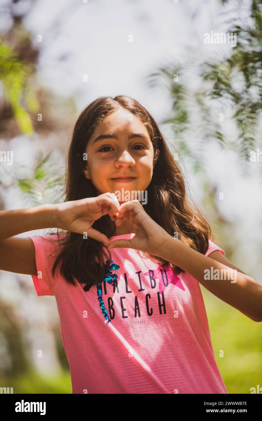 Girl making love heart sign hi-res stock photography and images - Alamy