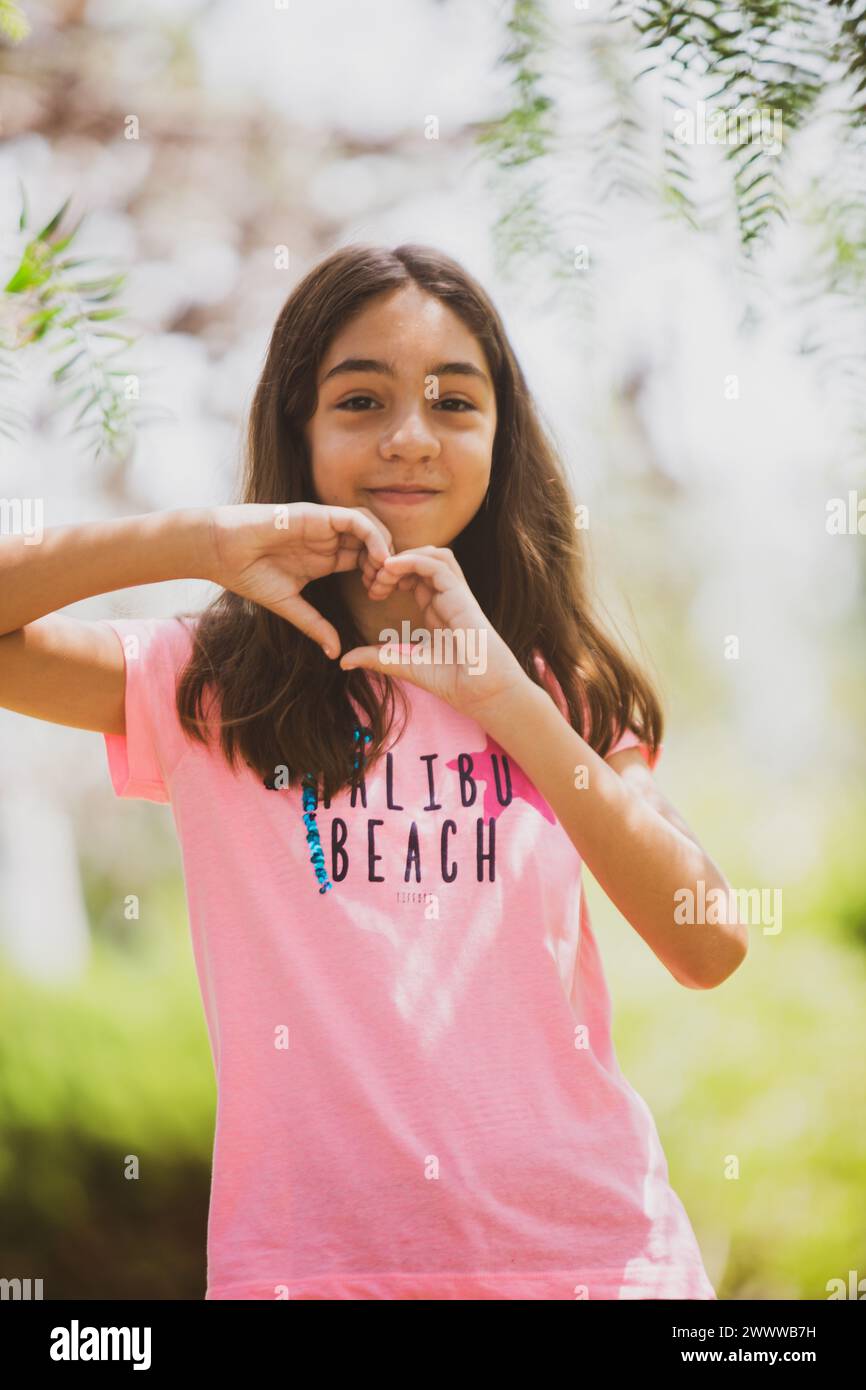 Girl making love heart sign hi-res stock photography and images - Alamy