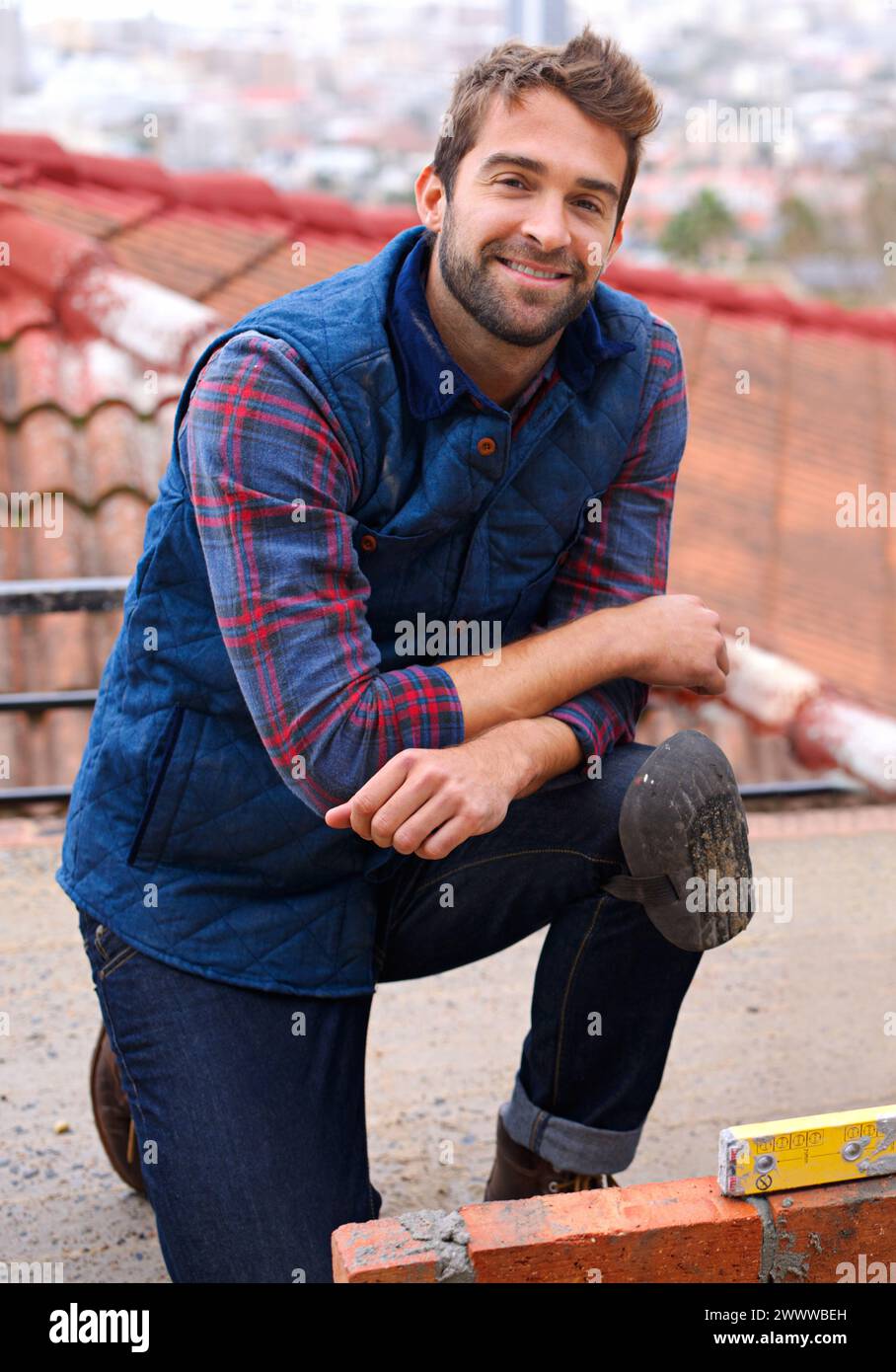 Bricklayer, smile and construction with man builder on roof, working ...