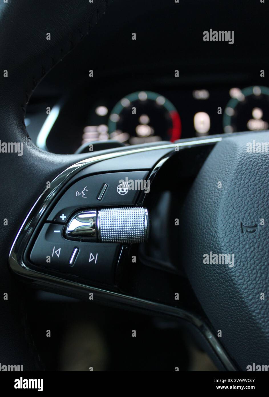 Heated steering wheel control buttons with blurred dashboard in car ...