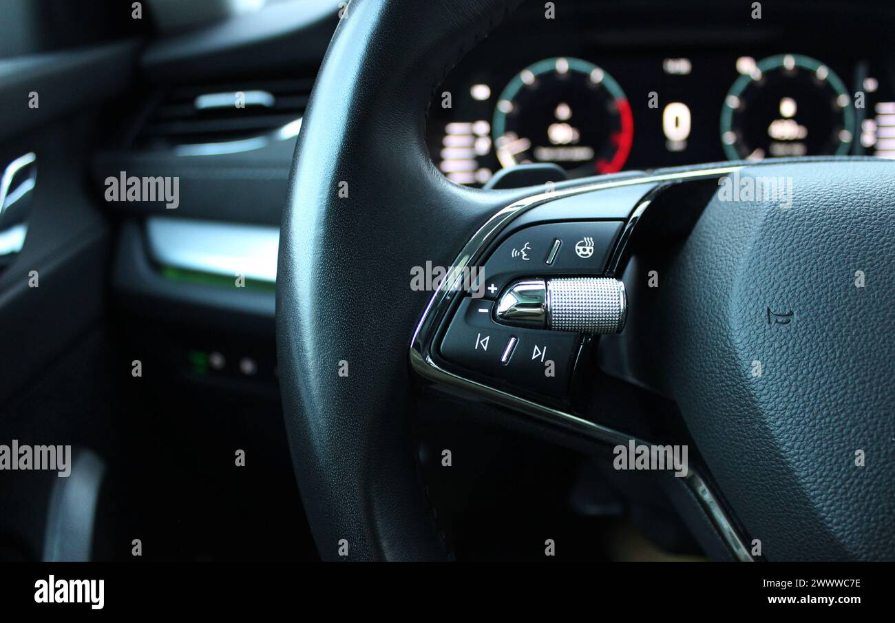 Defocused backlight of LED dashboard behind car steering wheel with ...
