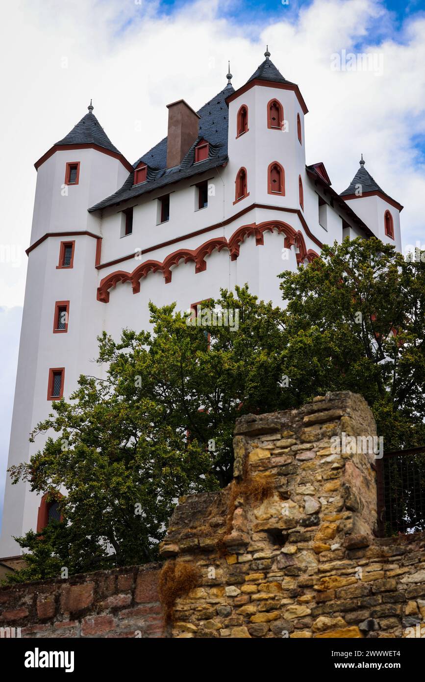Old German castle with blue sky that is painted white with red windows ...