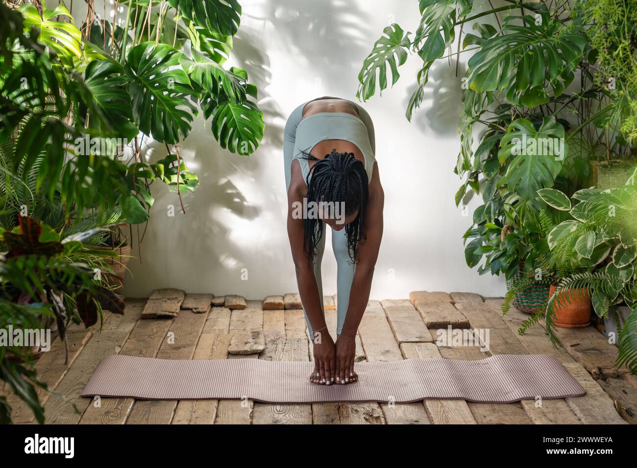 Fitness black girl do forward bend stretching warms up muscles before ...