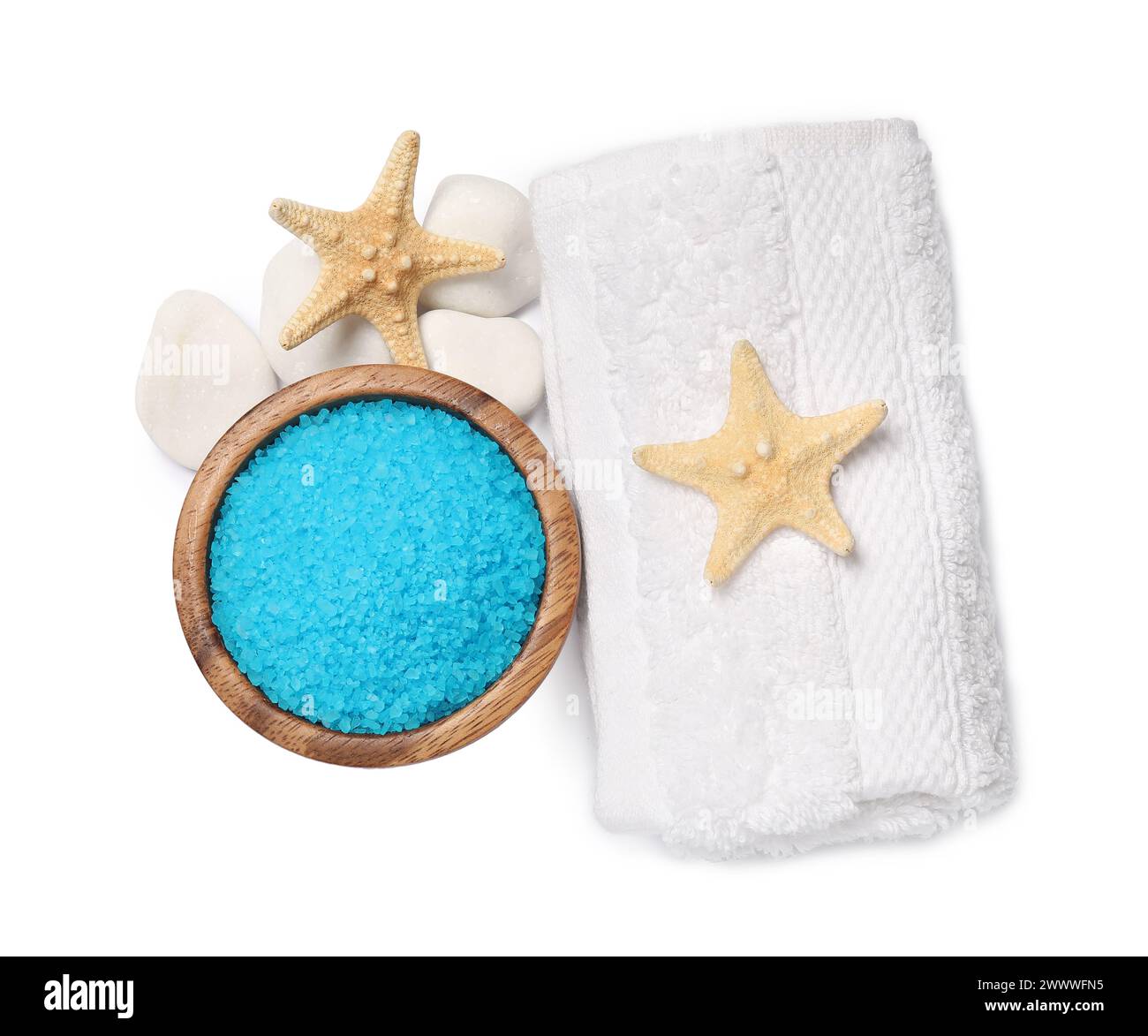 Light blue sea salt in bowl, spa stones, starfishes and towel isolated ...
