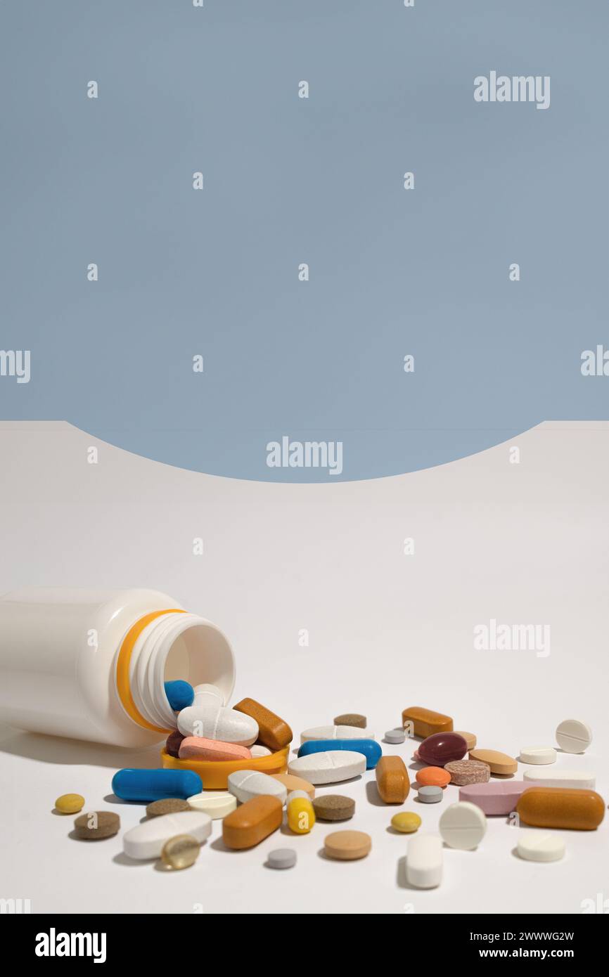 Tablets on the table. Pills are scattered on the table. Blue, medical ...