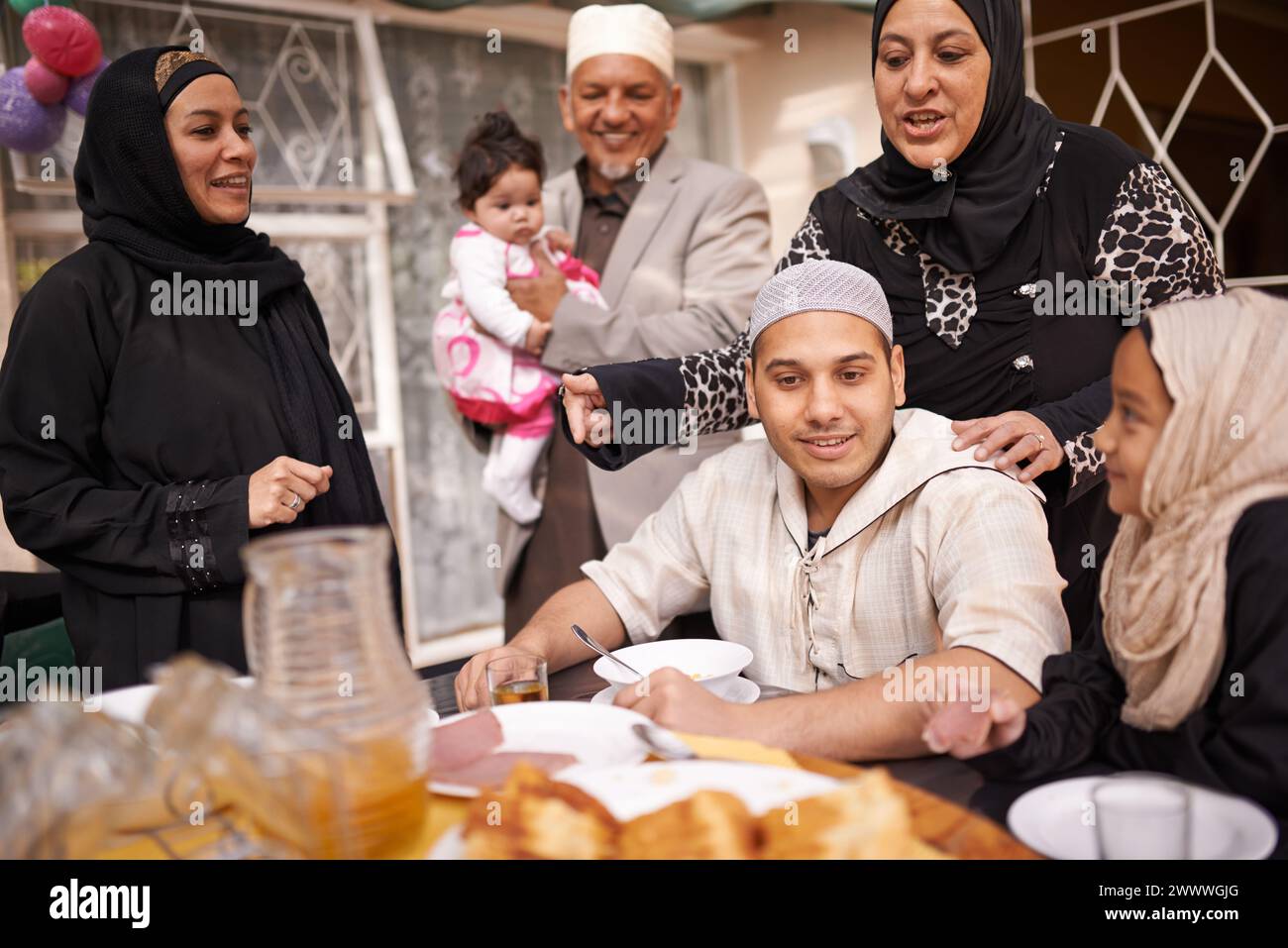 Muslim family, Eid and lunch by table with food for celebration ...